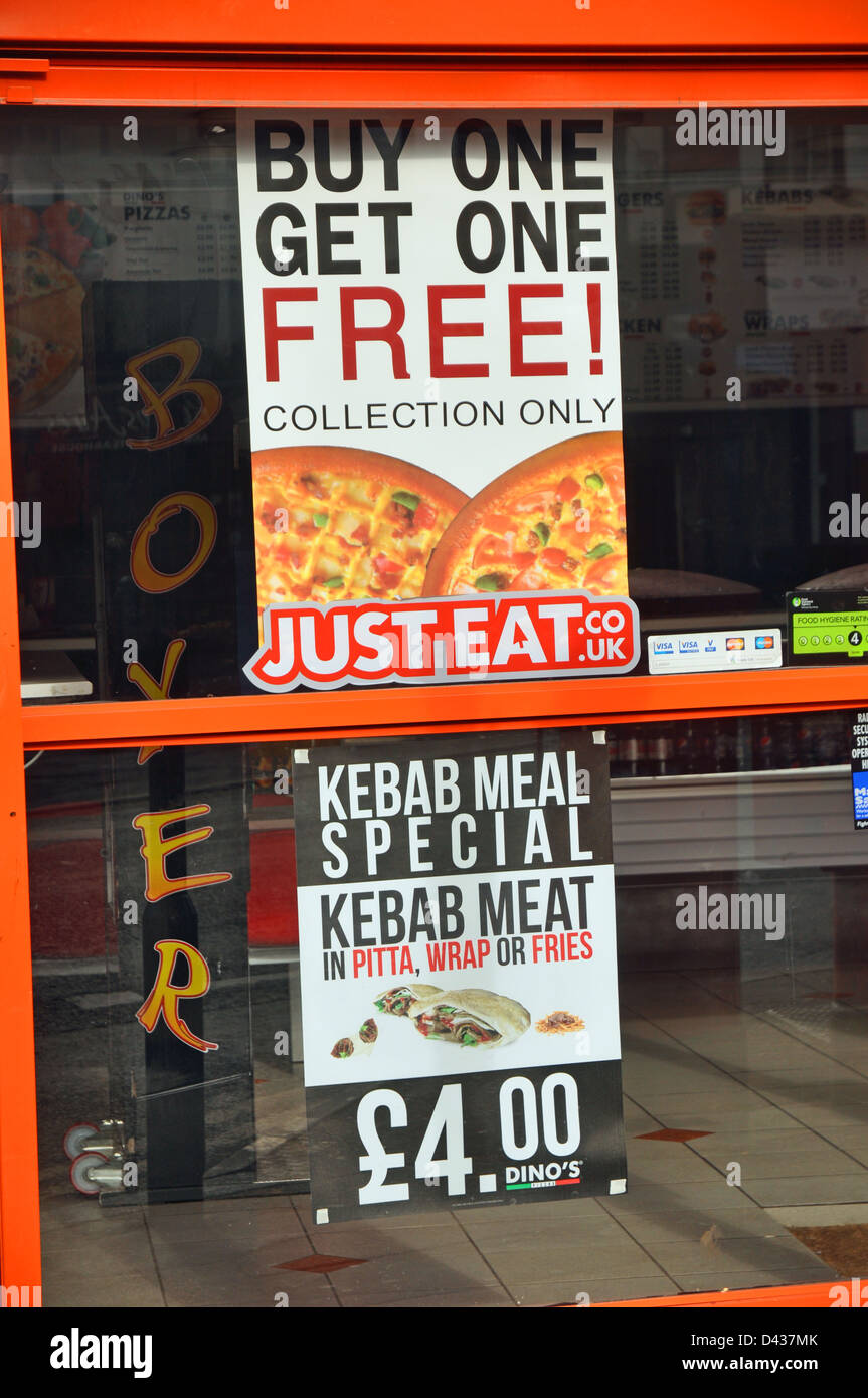 Poster advertising buy one get one free in food shop window Stock Photo ...
