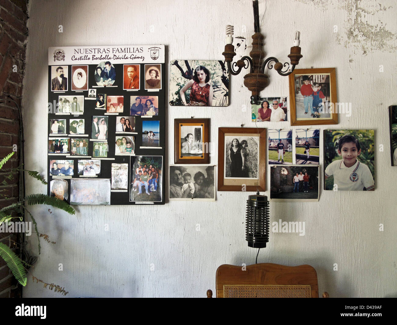 porch wall of Mexican middle class house home hung with 4 generations ...