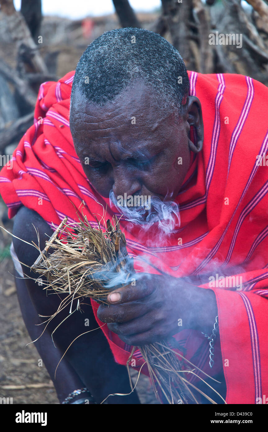 A masai man starts a fire with kindling Stock Photo - Alamy