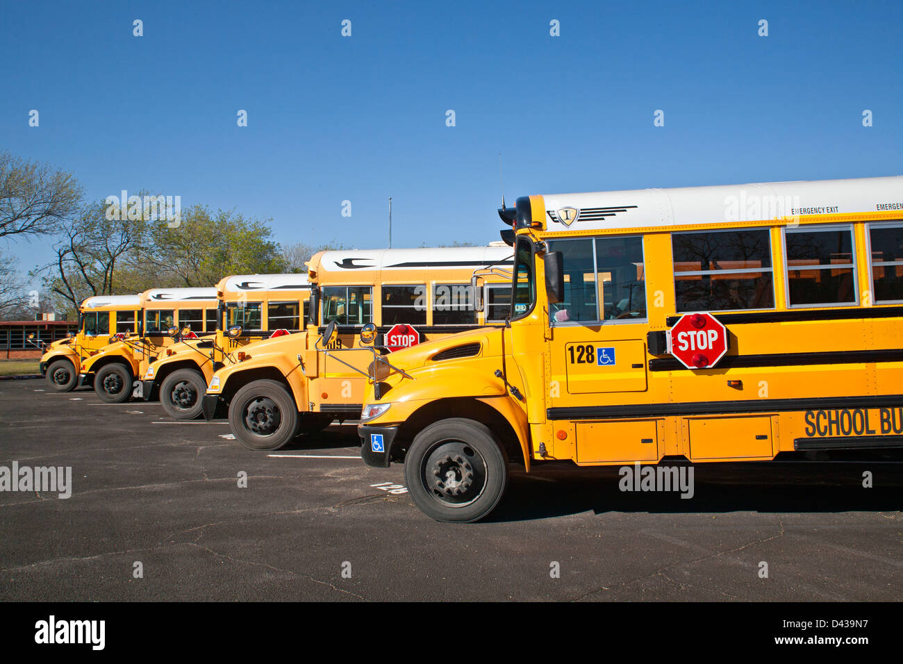 Public school buses lined up and parked in school bus parking lot Stock ...