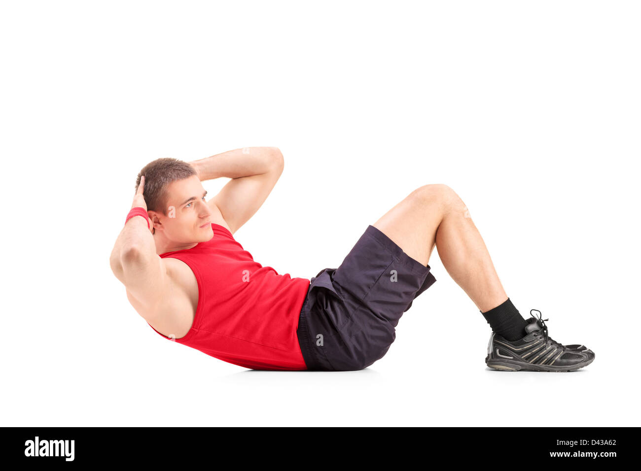 Young man doing abbs on the floor isolated on white background Stock ...