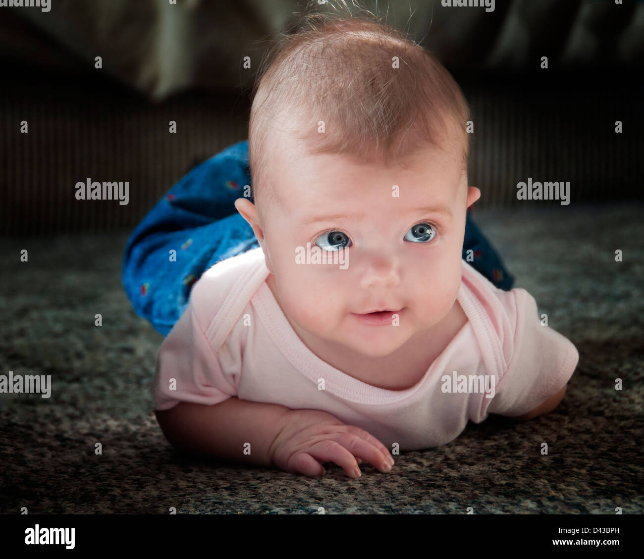 newborn infant baby girl crawling on her stomach Stock Photo - Alamy