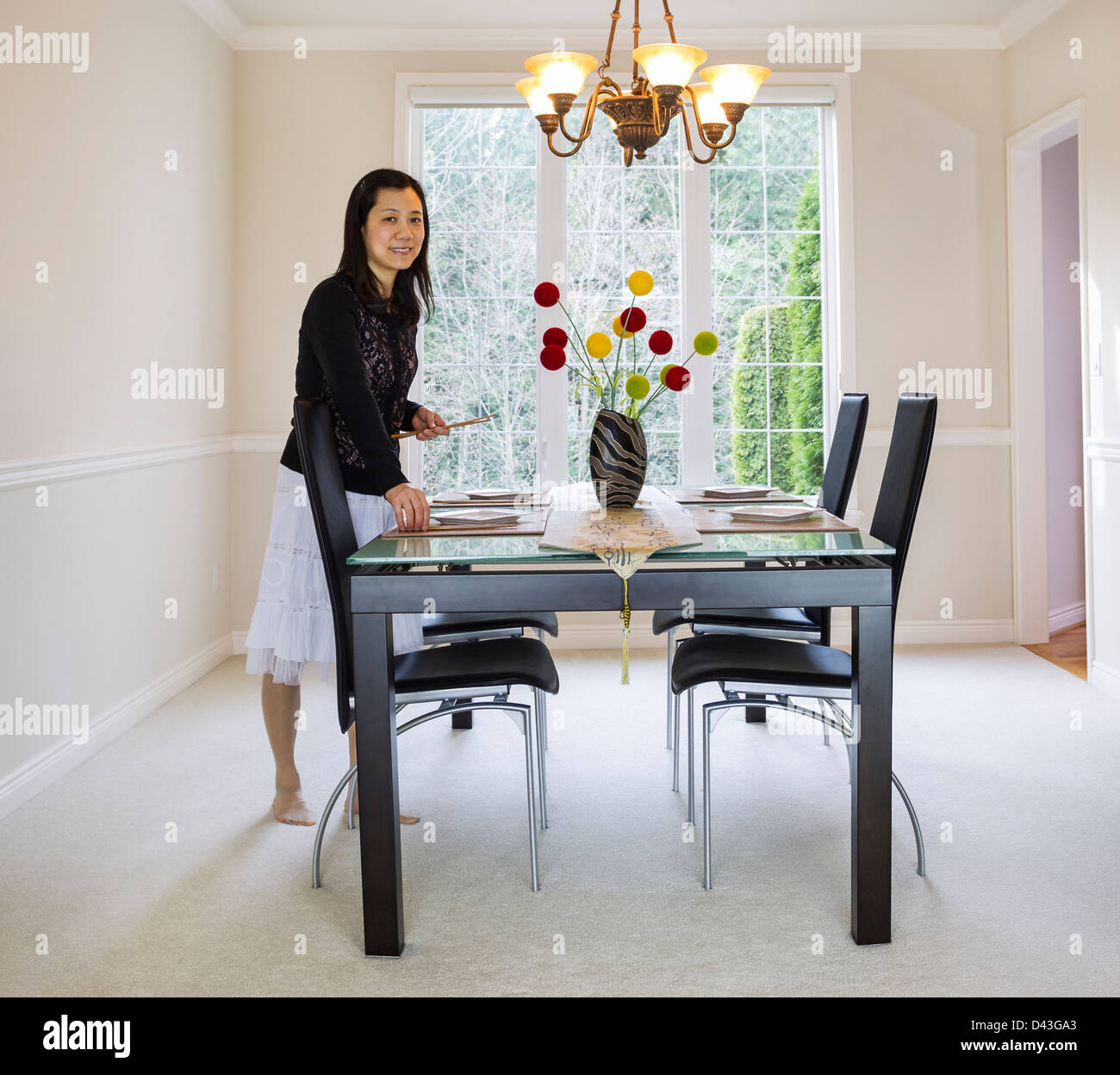 Mature woman setting formal dining room table Stock Photo - Alamy