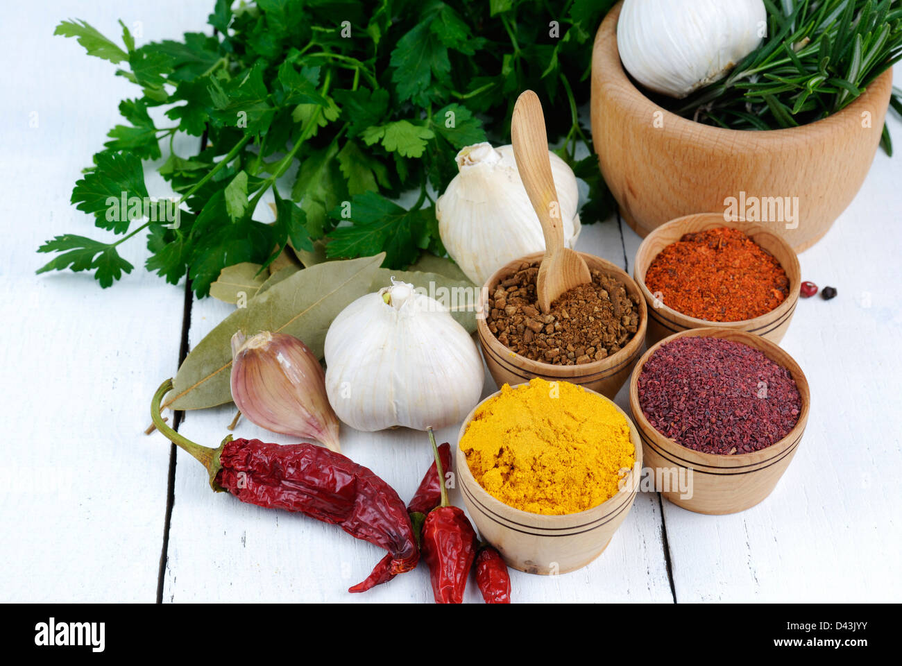 Different kinds of seasonings and herbs on the white oak table Stock ...