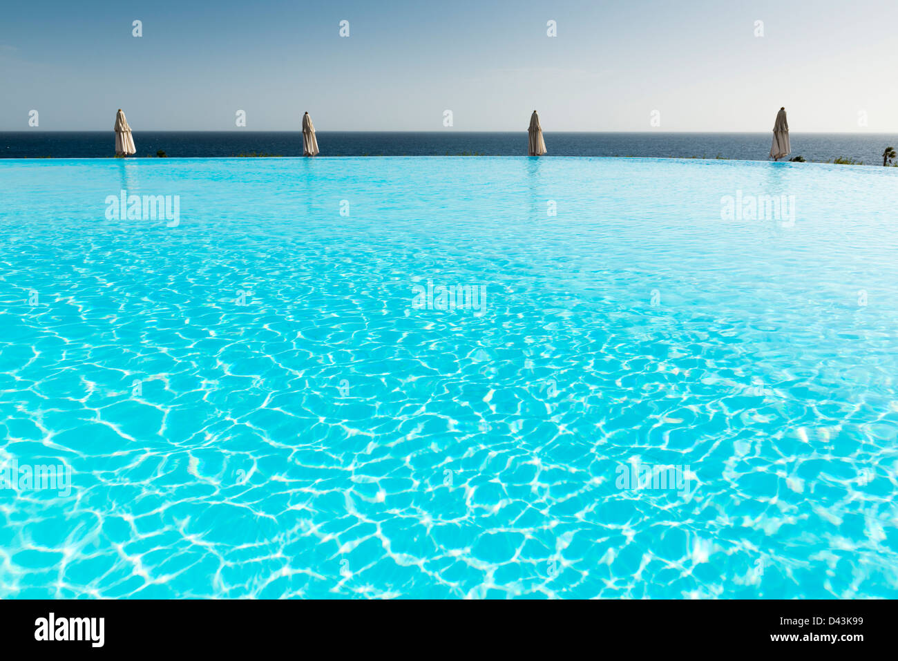Empty blue infinity pool in crisp morning light Stock Photo - Alamy