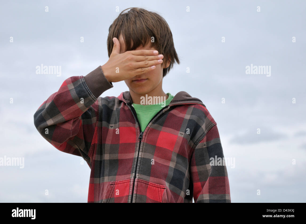 Boy (10) hand covering face hi-res stock photography and images - Alamy