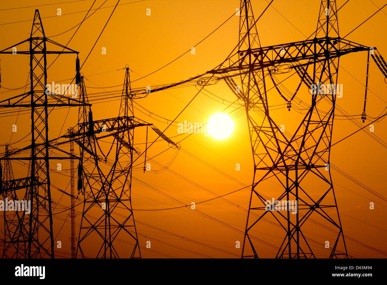 Transmission towers on sunset sky Stock Photo - Alamy