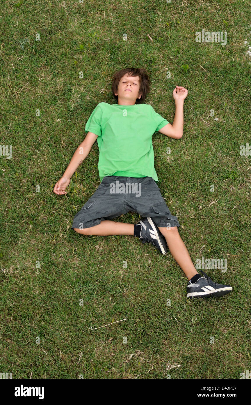 Boy Lying on Grass, Ile de Re, Poitou-Charentes, France Stock Photo - Alamy