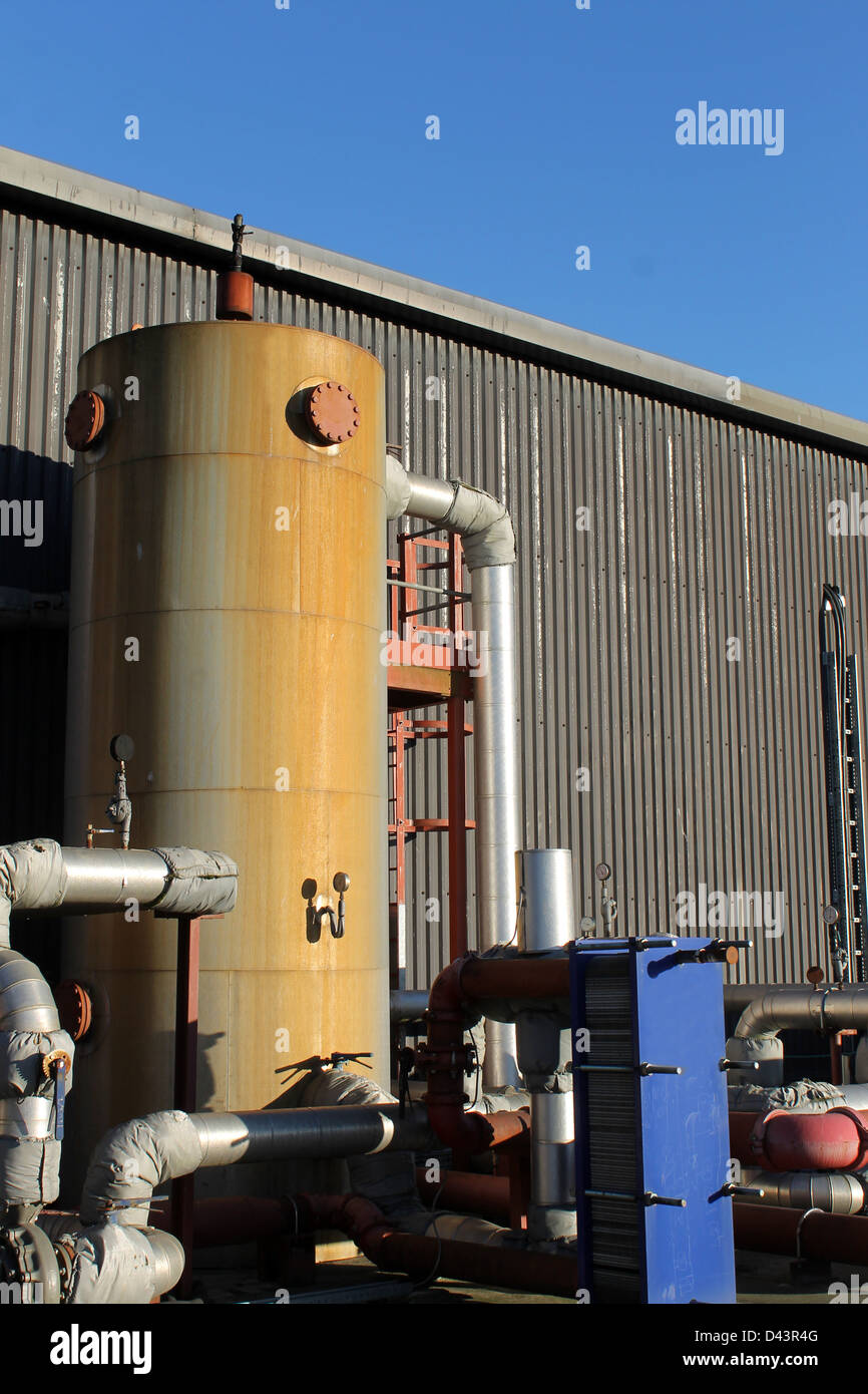 Tank and pipes outside industrial building Stock Photo - Alamy