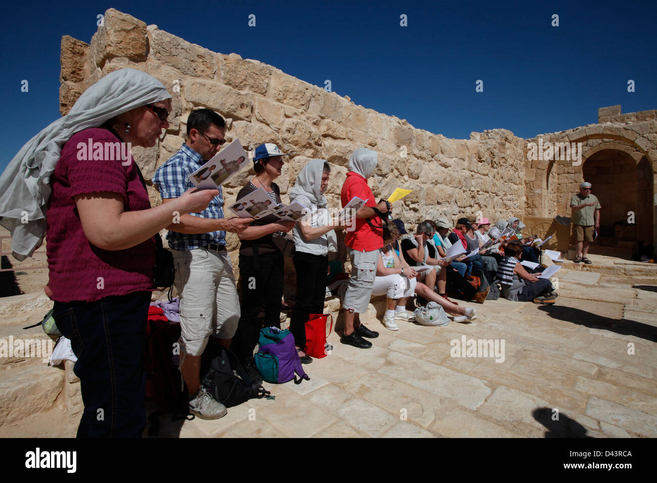 A group of Christian tourists praying at the Northern Byzantine Church ...