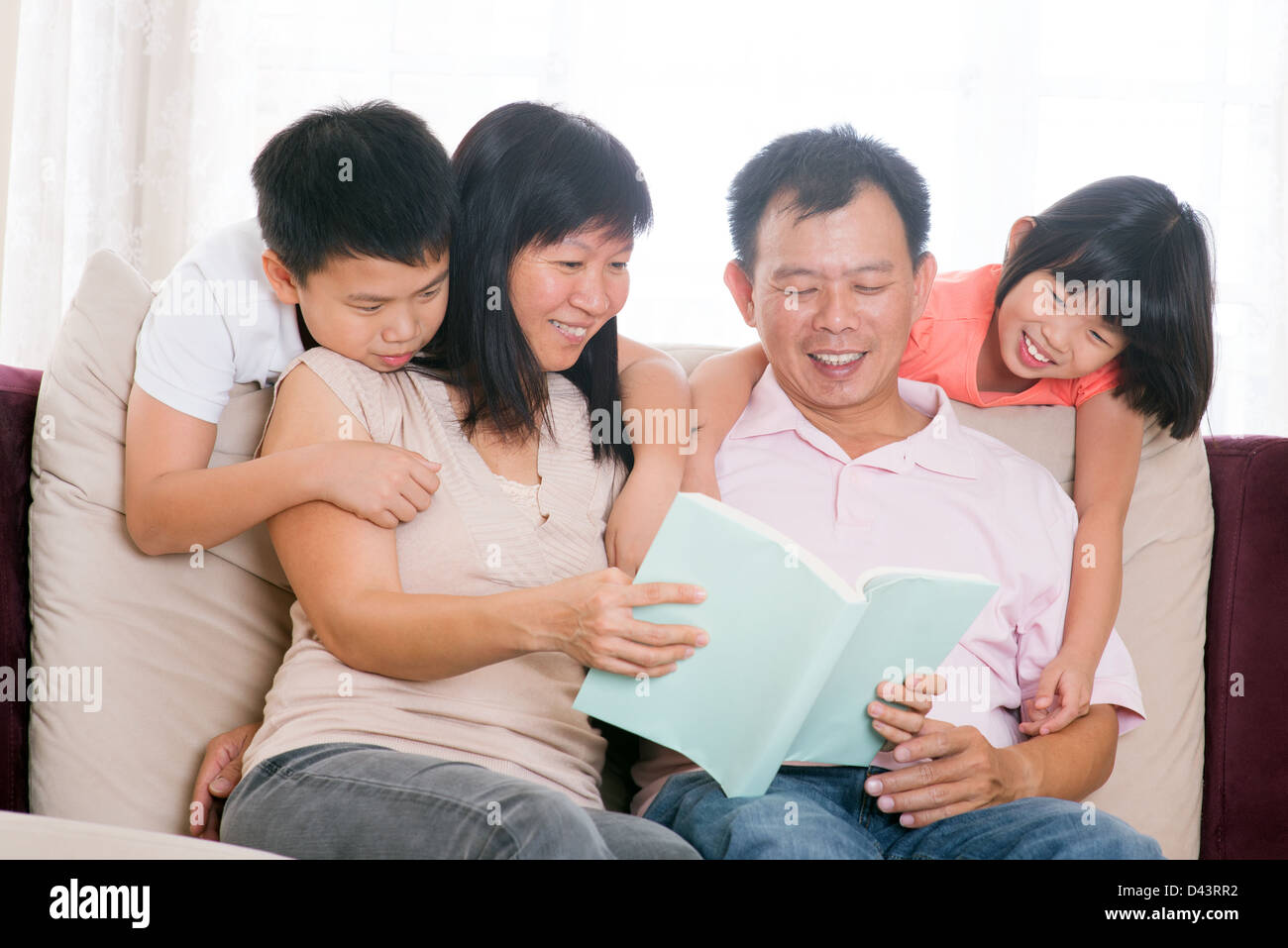 Southeast Asian family living lifestyle. Parents and children reading ...