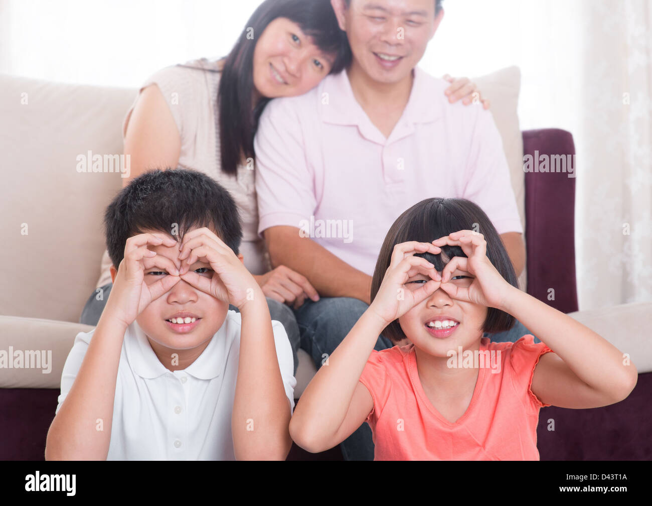 Southeast Asian family having fun at home Stock Photo - Alamy