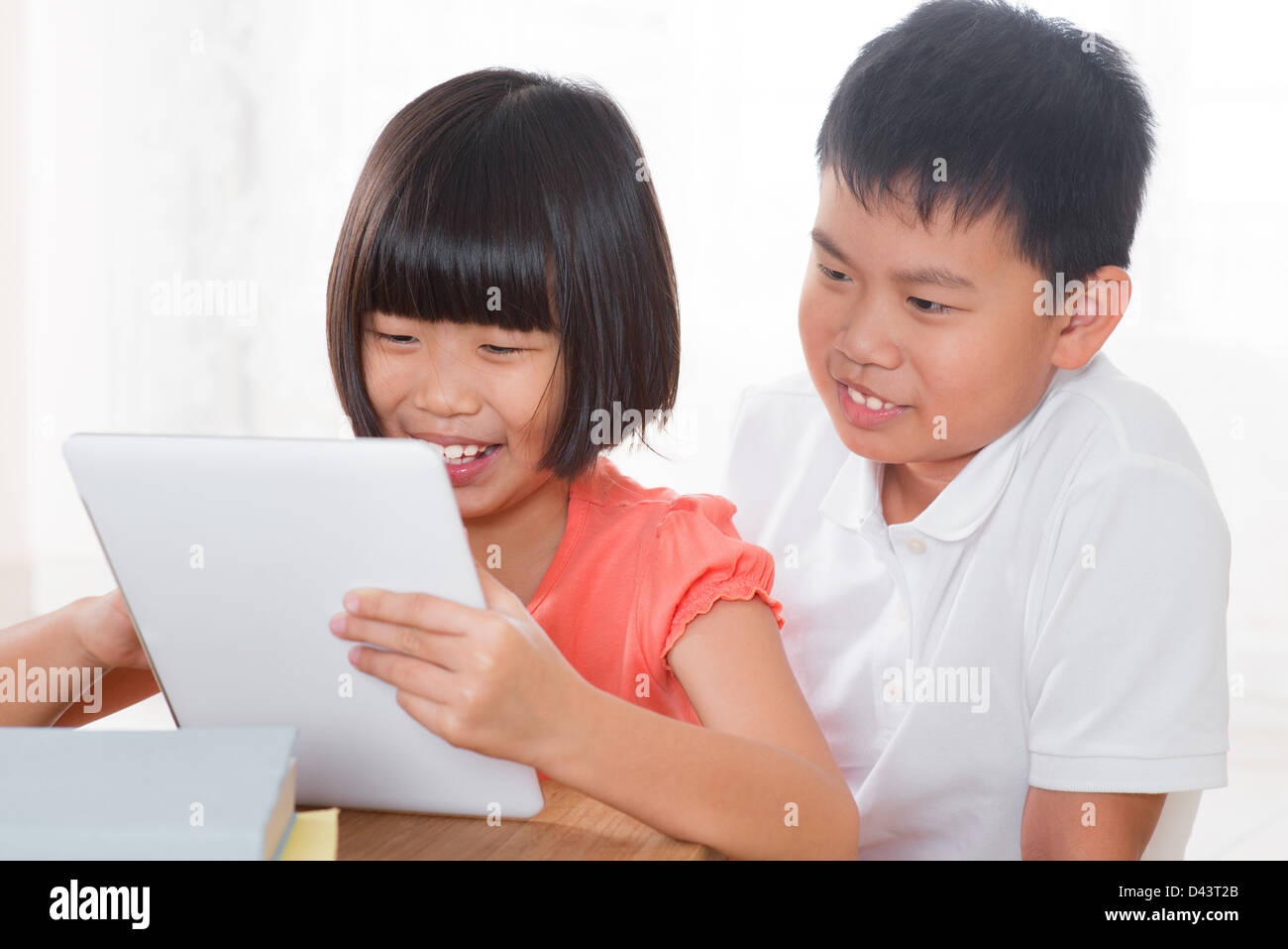 Southeast Asian family living lifestyle at home. Children using digital ...