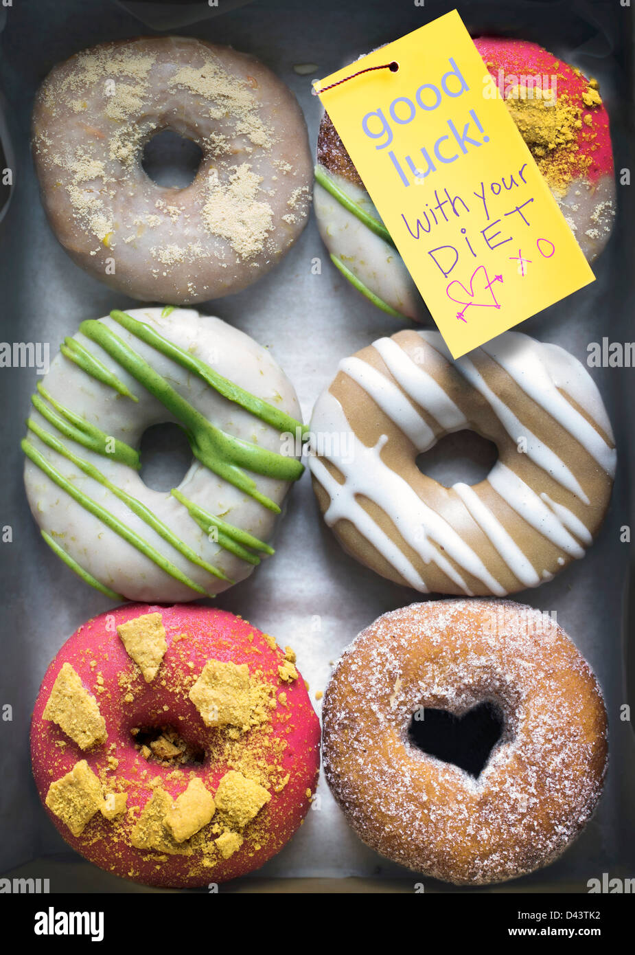 Designer Donuts with Note Stock Photo - Alamy