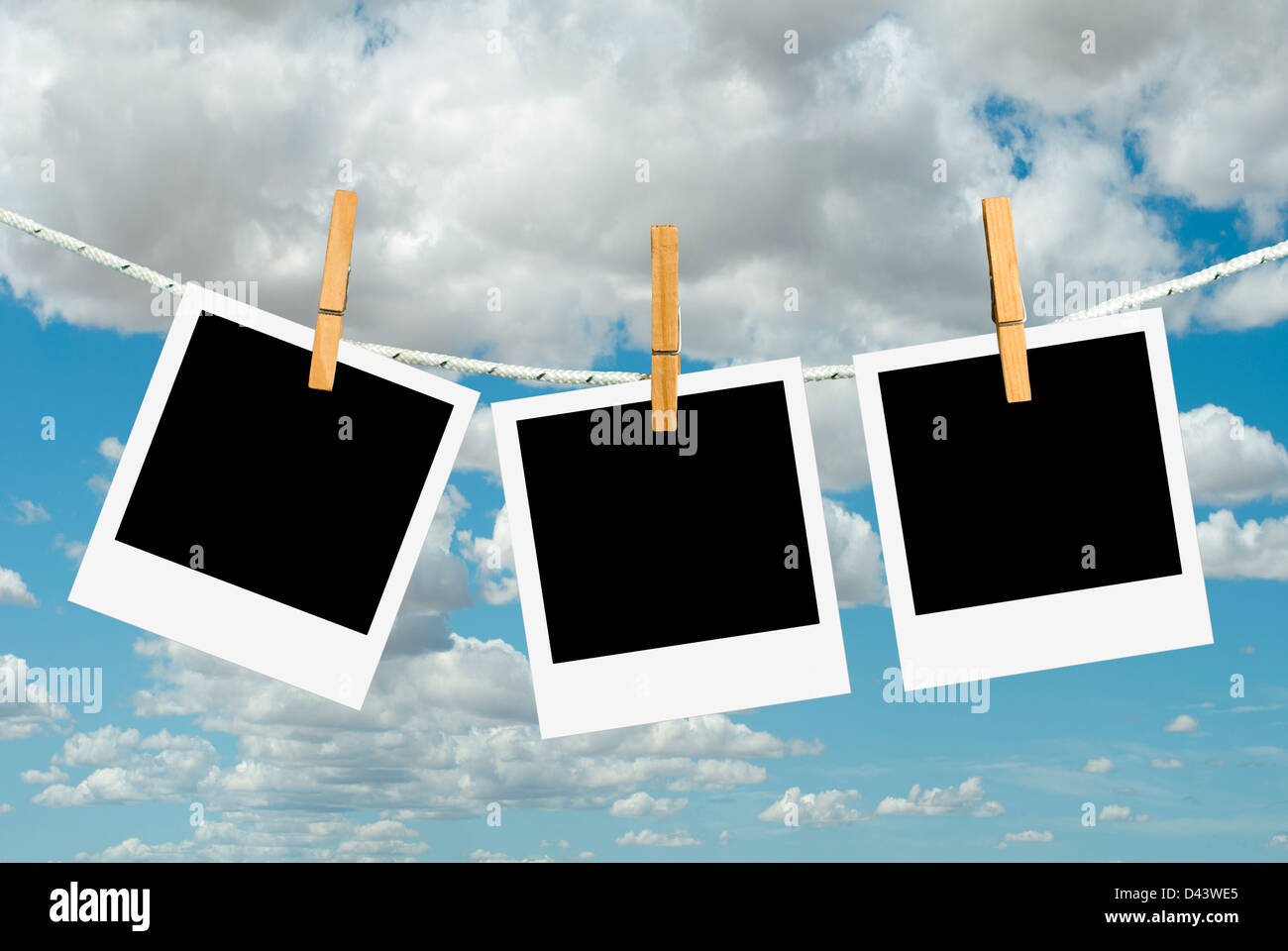 Pictures template hooked on a rope. Sky background Stock Photo - Alamy