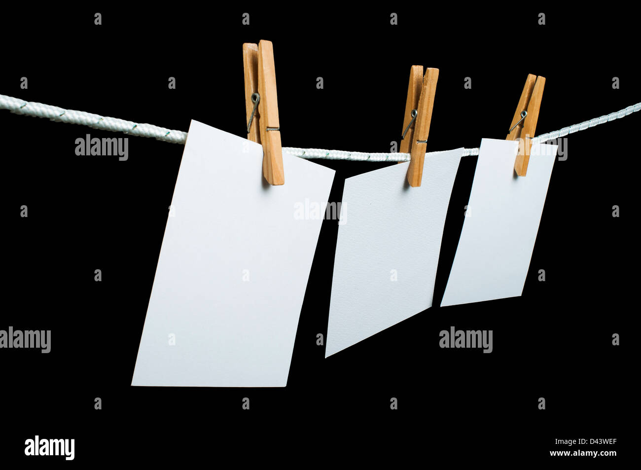 Note papers hooked on a rope. Balck isolated studio shot Stock Photo ...