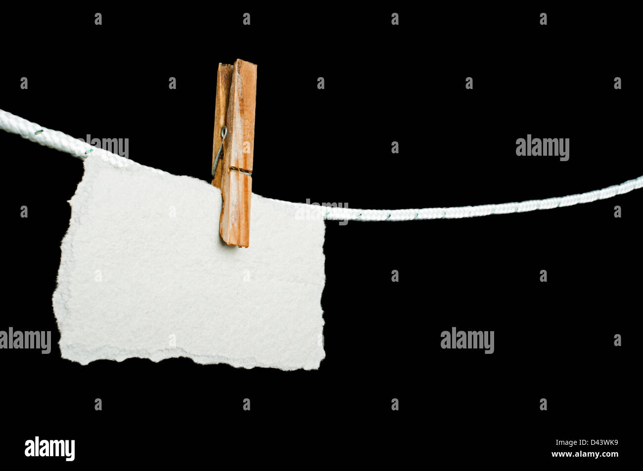 Note paper hooked on a rope. Balck isolated studio shot Stock Photo - Alamy