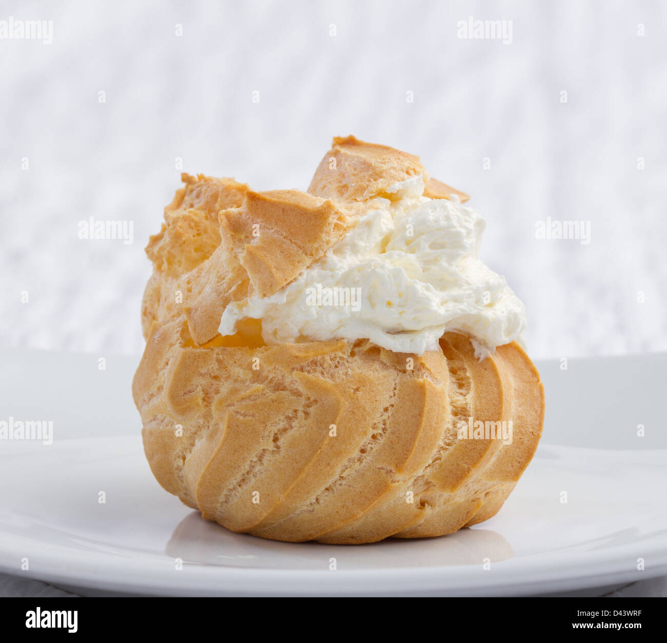 Big eclair appetizer looks eatable with mousse cream on dish Stock ...