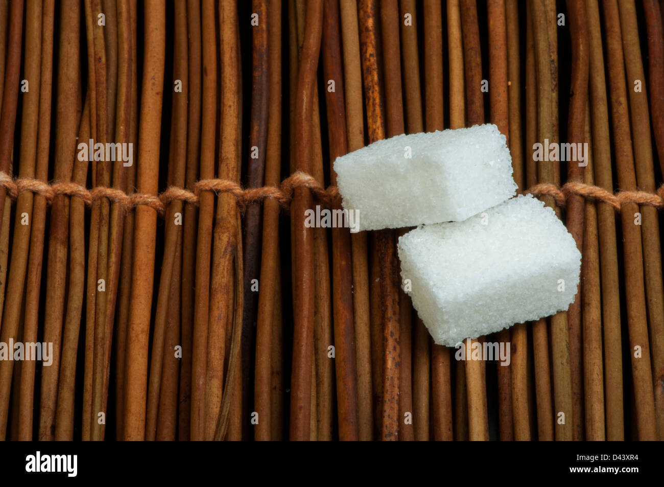 Sugar lumps on wooden base. Studio shot Stock Photo - Alamy