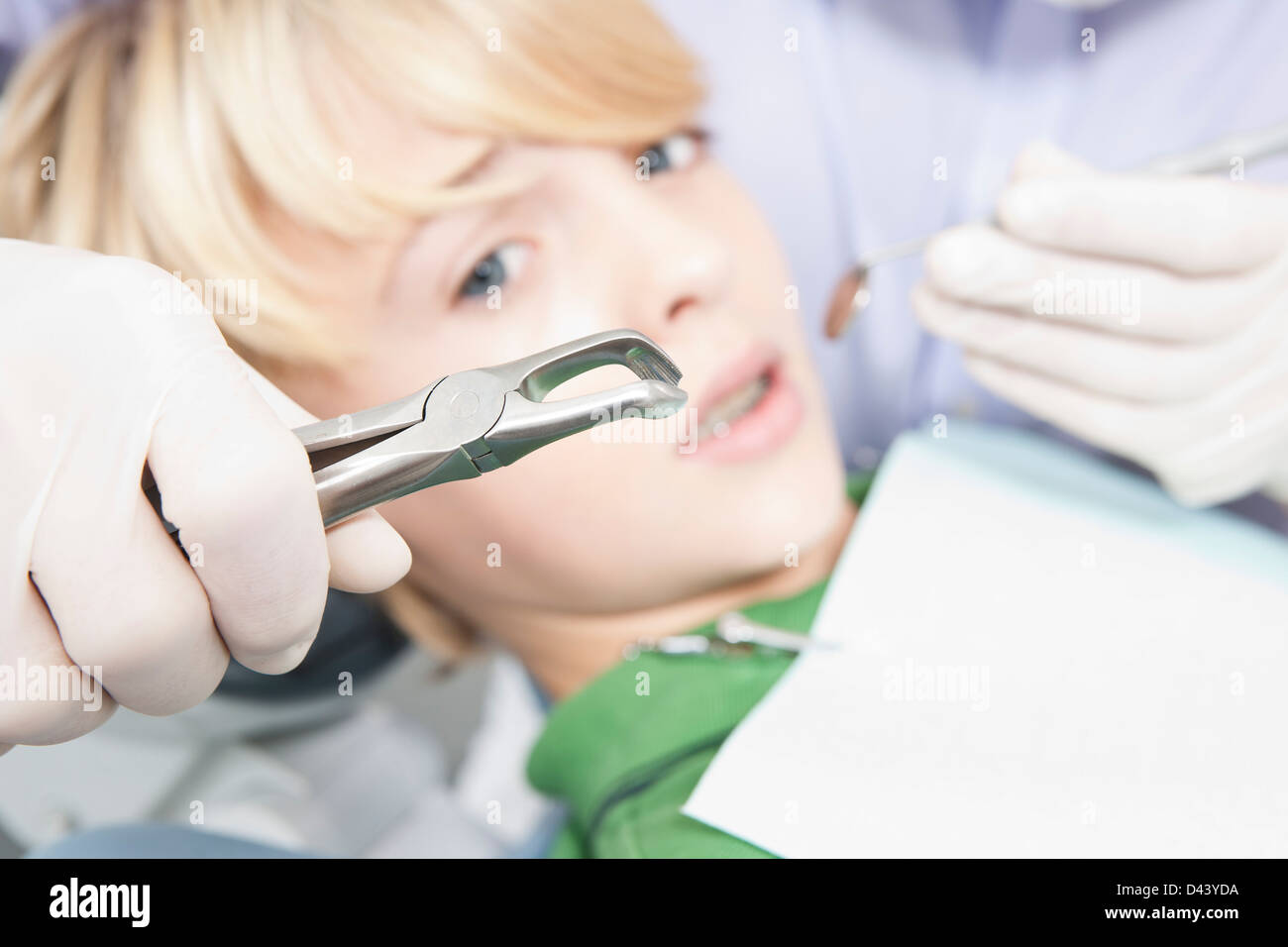 Anxious Boy looking at Dental Instruments during Appointment, Germany ...