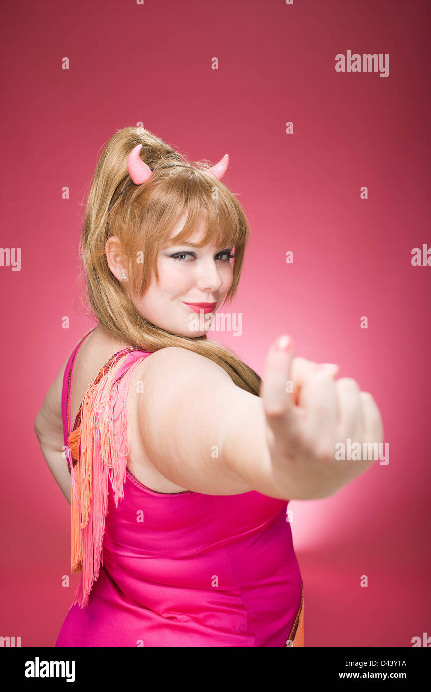 Portrait of Woman Wearing Devil Horns Making Hand Gesture Stock Photo ...