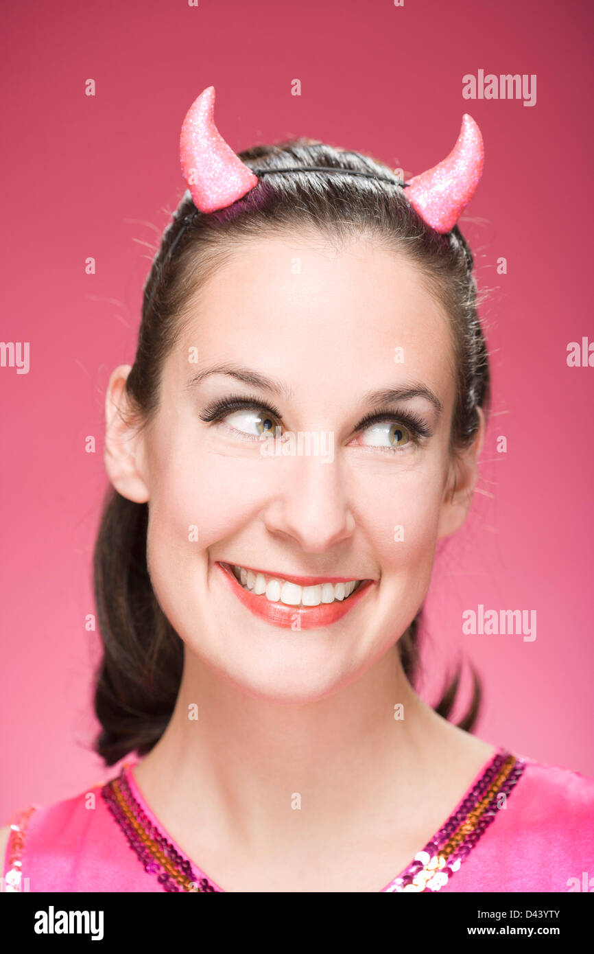 Portrait of Woman Wearing Devil Horns and Smiling Stock Photo - Alamy