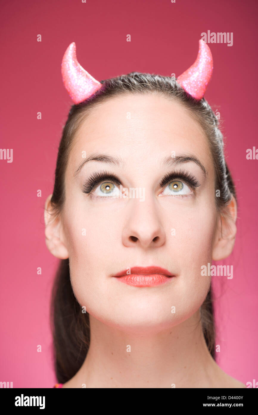Portrait of Woman Wearing Devil Horns Looking Up Stock Photo - Alamy