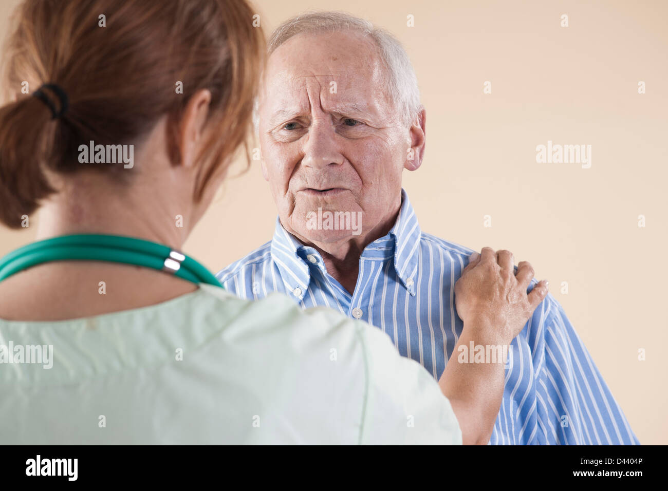 Senior Man being Examined by Medical Health Care Provider in Medical ...