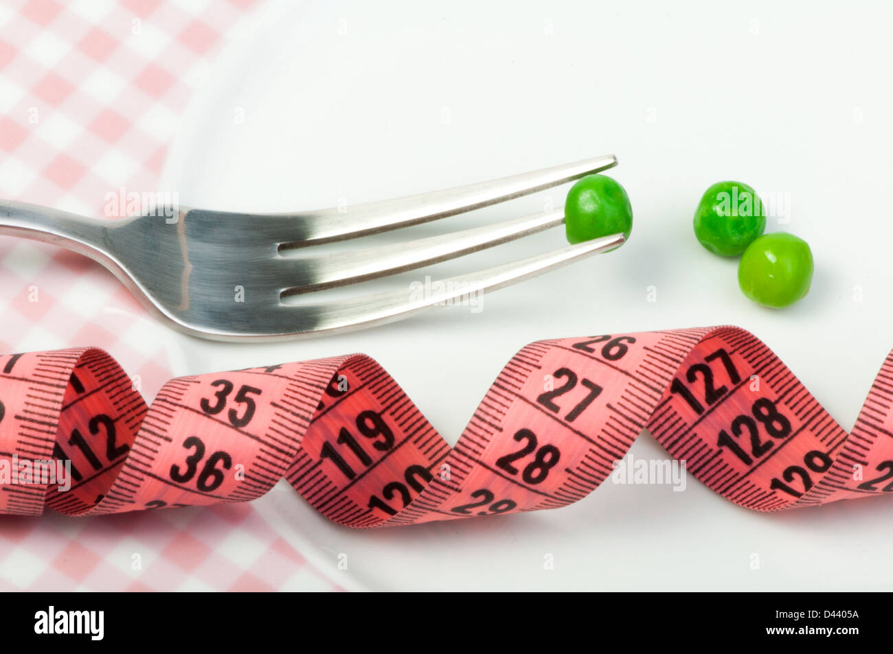 Plate with peas and centimeter measure close up Stock Photo - Alamy