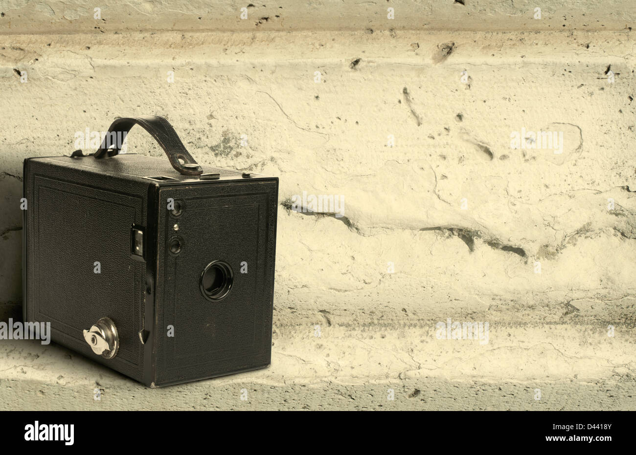 Old vintage camera stone wall background Stock Photo - Alamy