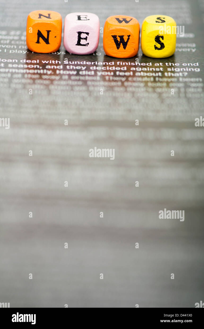Word news.Wooden cubes on newspaper. Close up studio shot Stock Photo ...