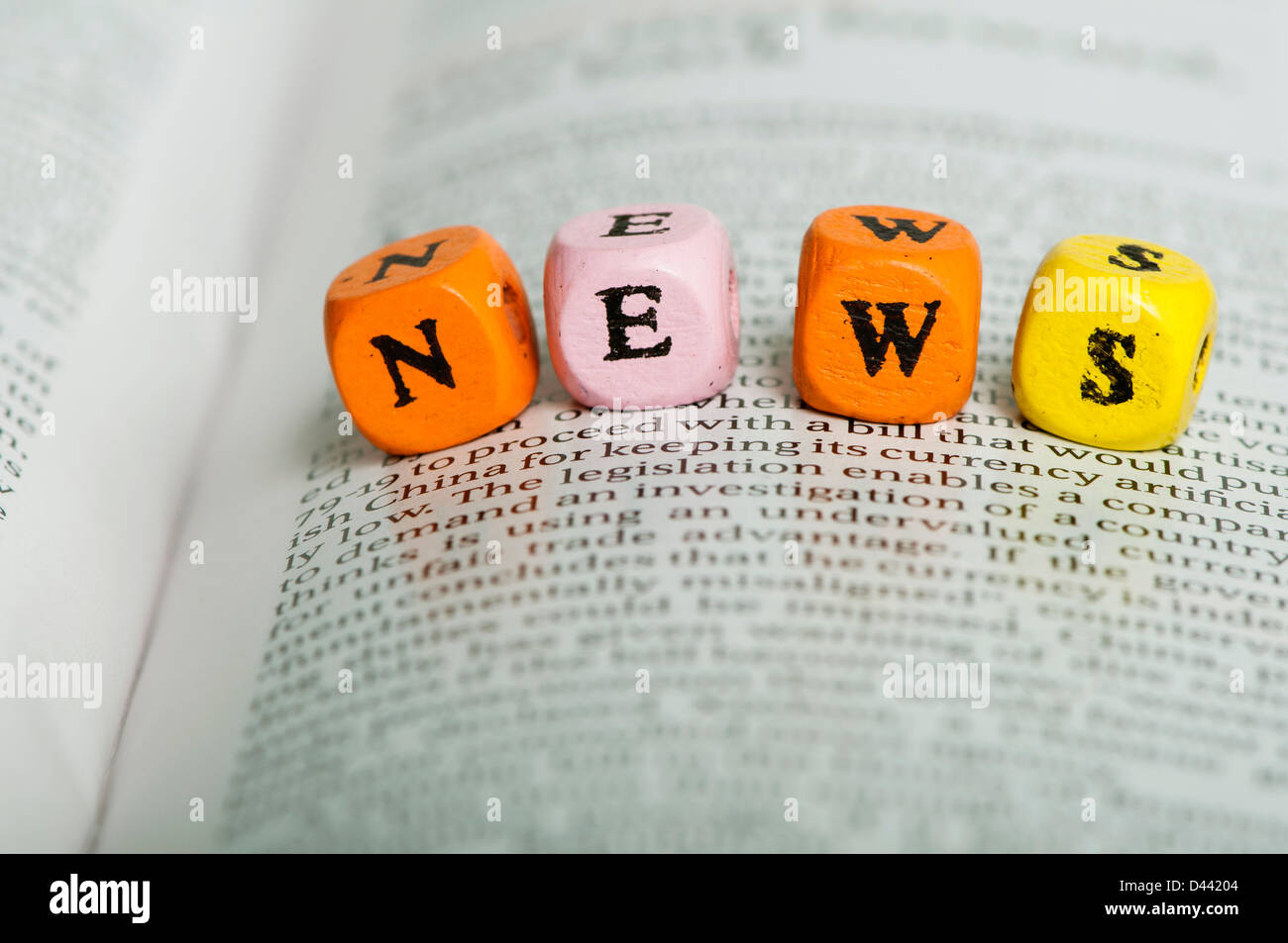 Word news.Wooden cubes on newspaper. Close up studio shot Stock Photo ...