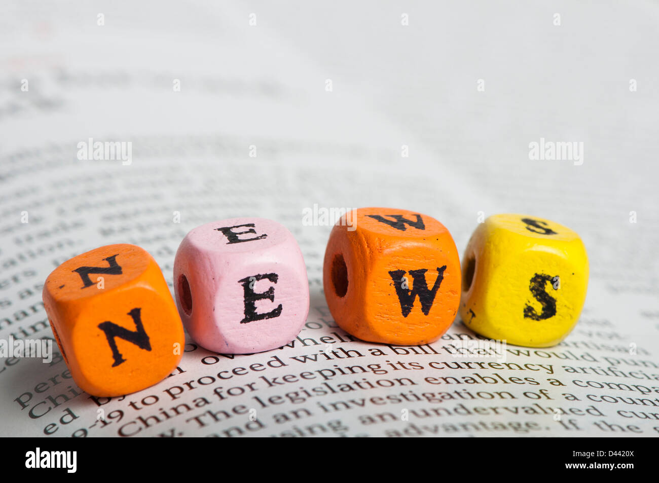 Word news.Wooden cubes on newspaper. Close up studio shot Stock Photo ...