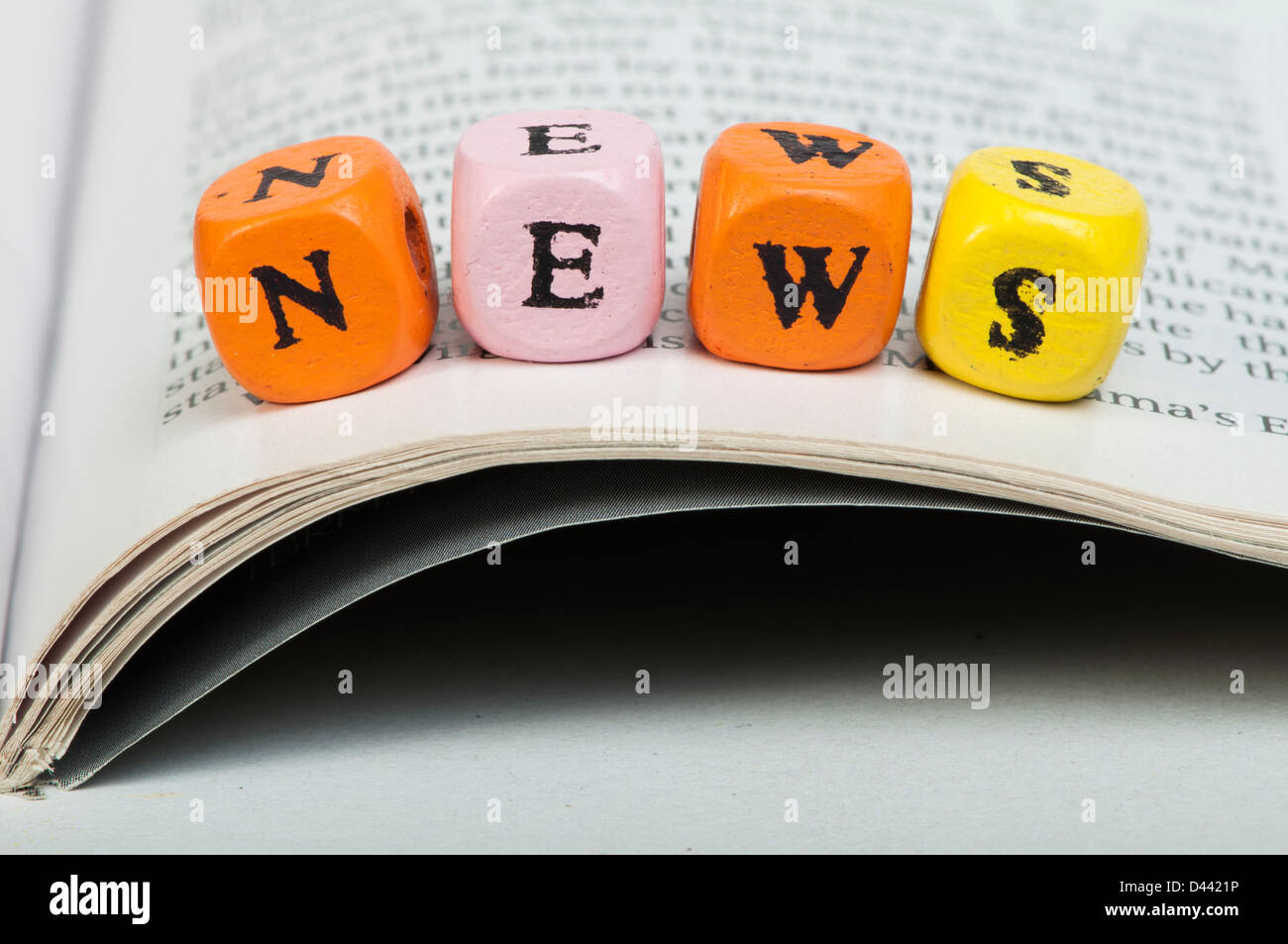 Word news.Wooden cubes on newspaper. Close up studio shot Stock Photo ...