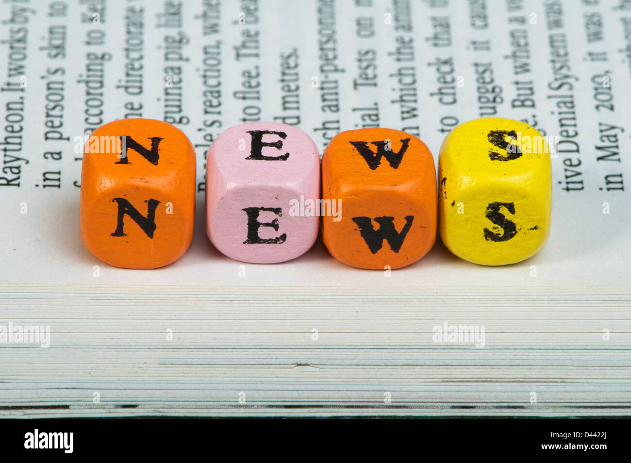 Word news.Wooden cubes on newspaper. Close up studio shot Stock Photo ...