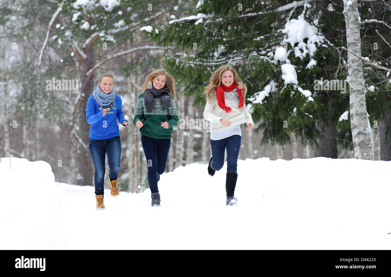 Three girls run on the forest path Stock Photo - Alamy