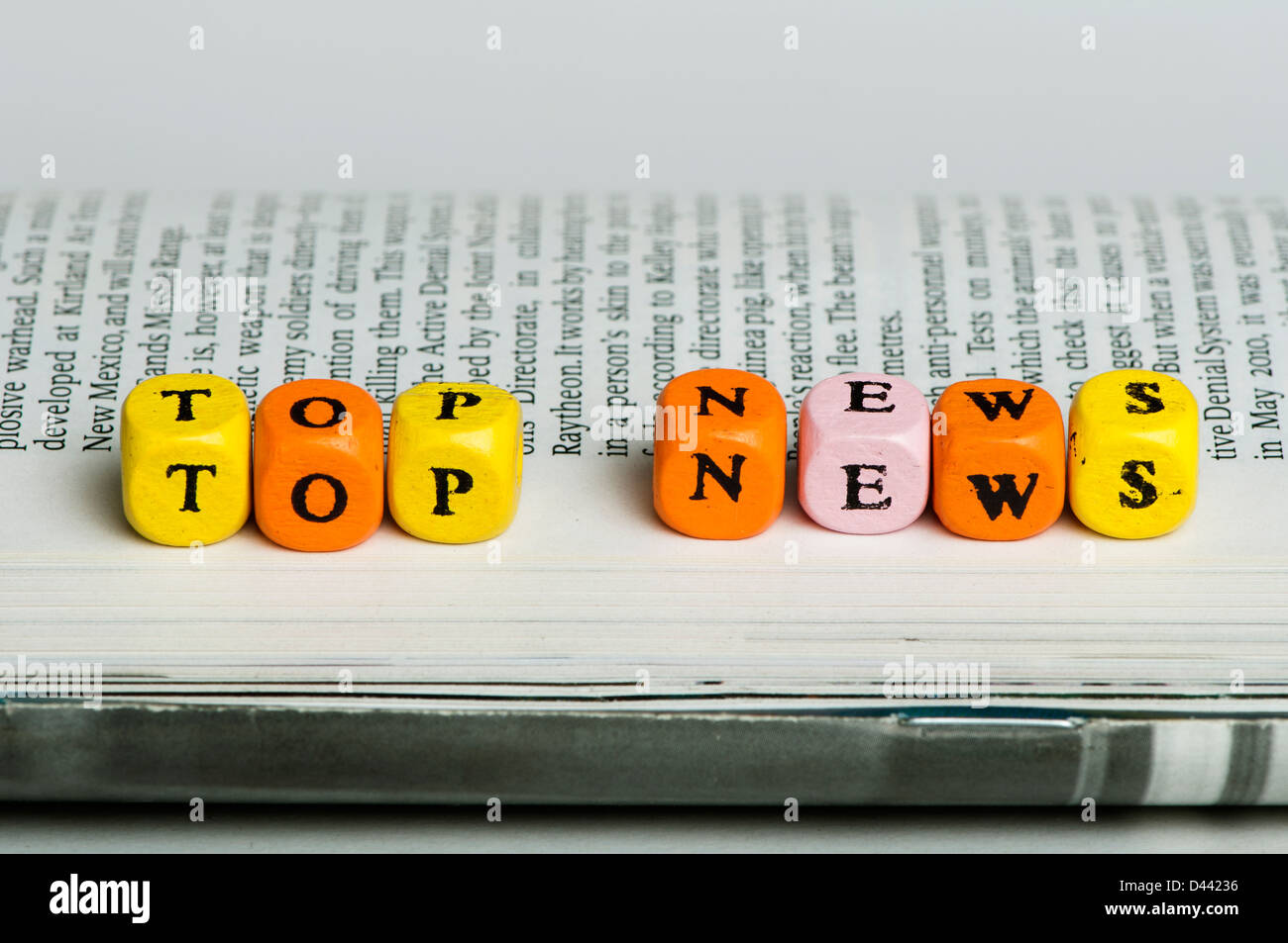Word top news.Wooden cubes on newspaper. Close up studio shot Stock ...