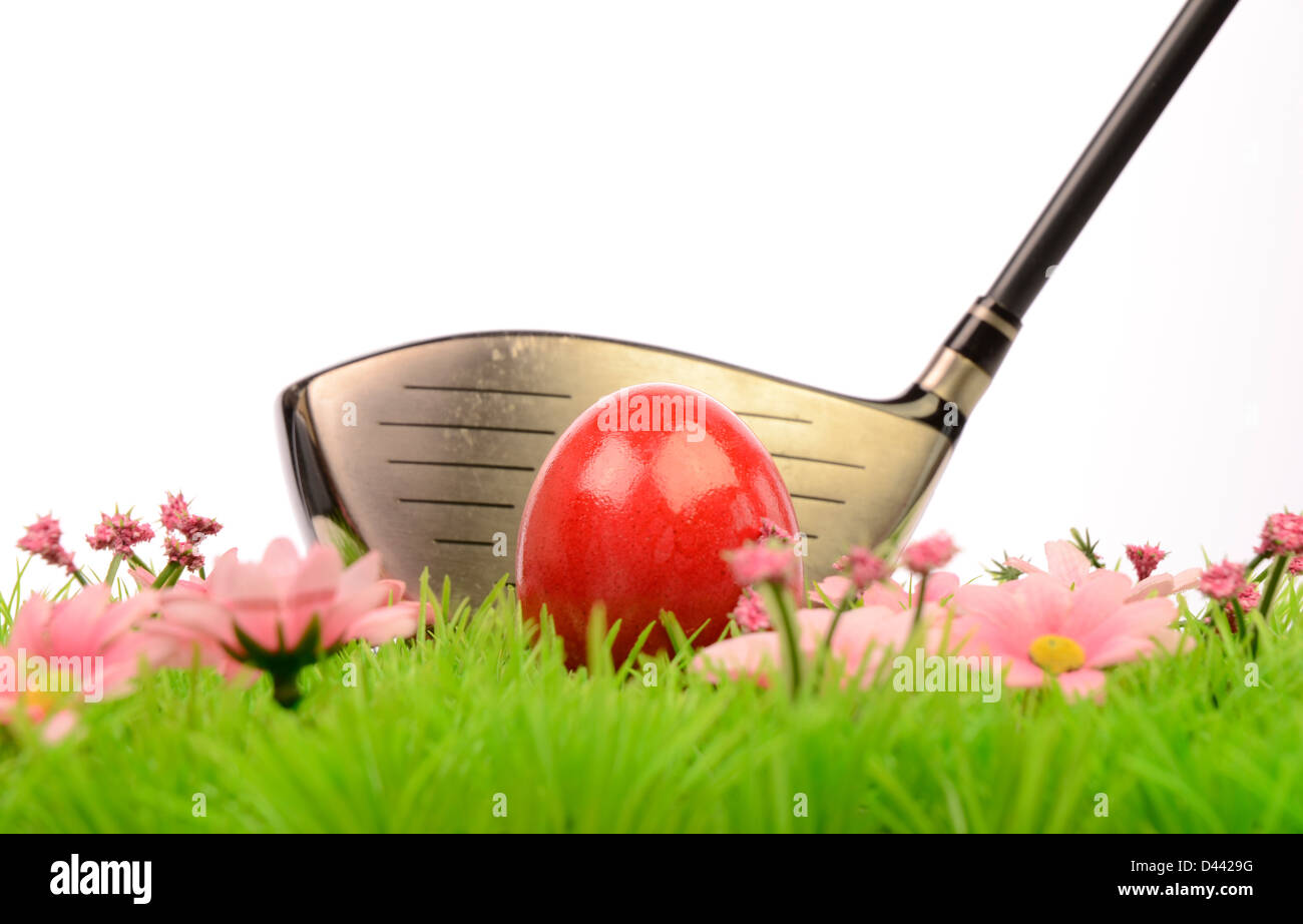 Red Easter egg on a green meadow with a golf Stock Photo - Alamy
