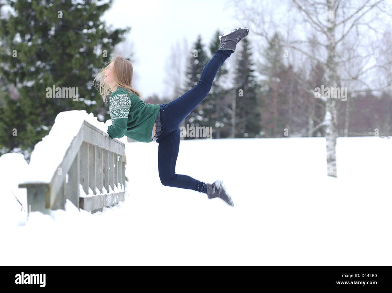 Girl performs gymnastic exercise in the fresh air in the winter Stock ...