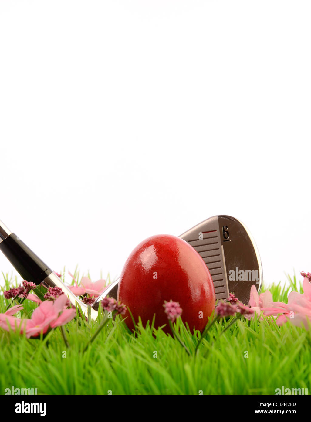Red Easter egg on a green meadow with a golf club Stock Photo - Alamy