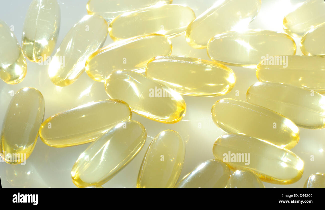 Fish oil capsules closeup on white background Stock Photo - Alamy