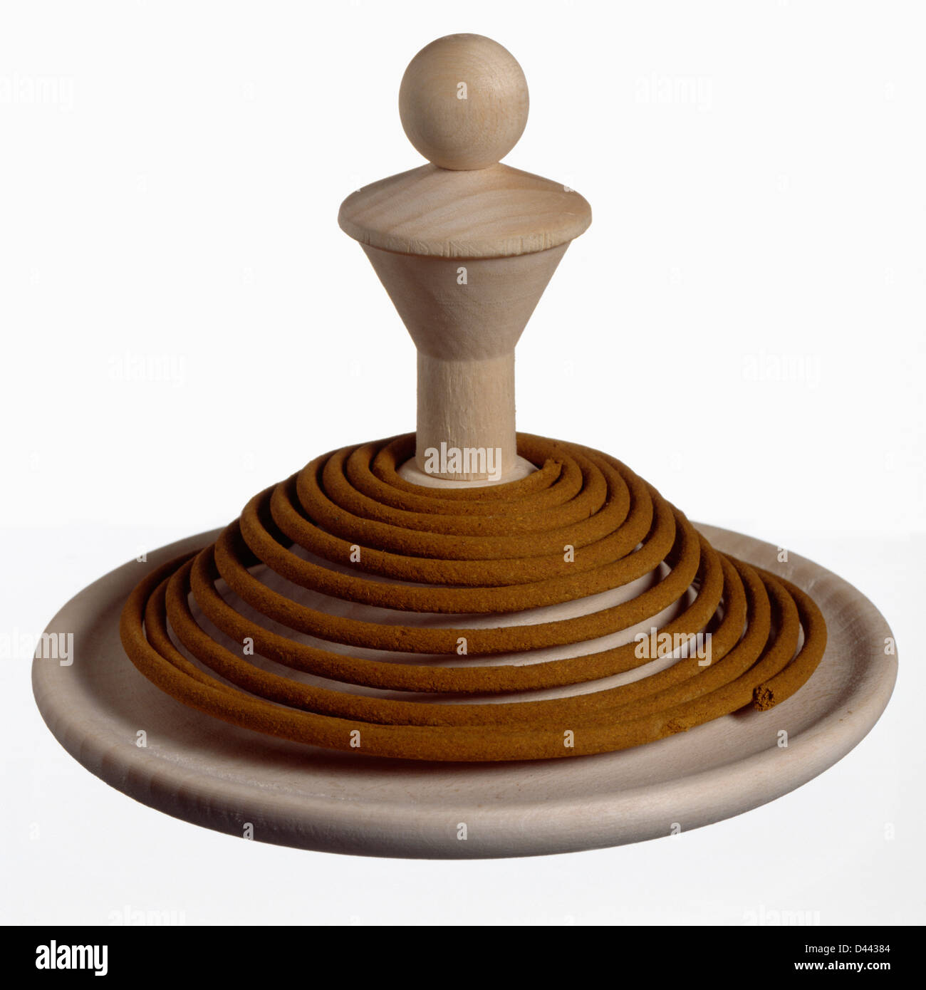 Close-up of incense coil on circular wooden holder Stock Photo - Alamy