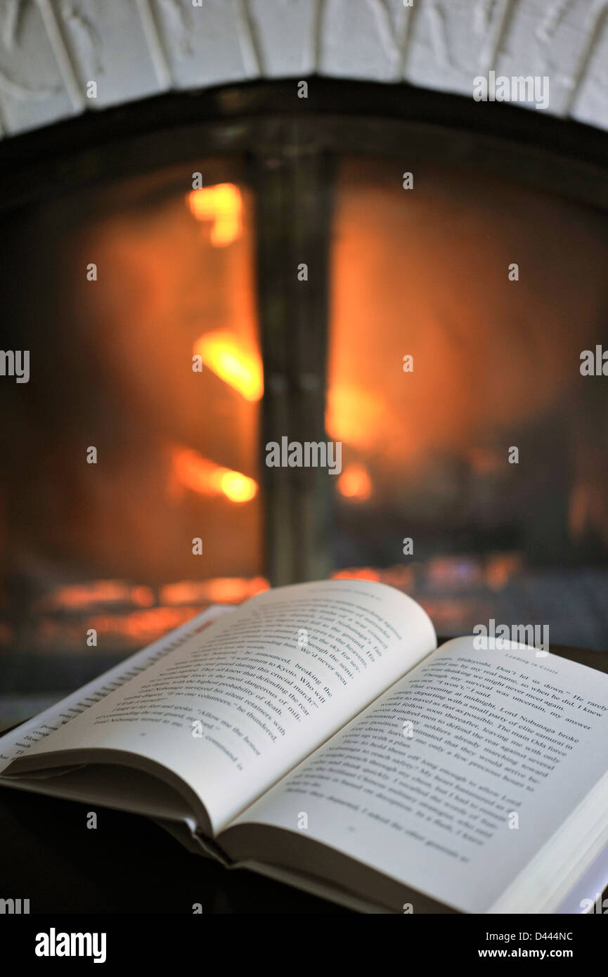 Open book by a fireplace Stock Photo - Alamy