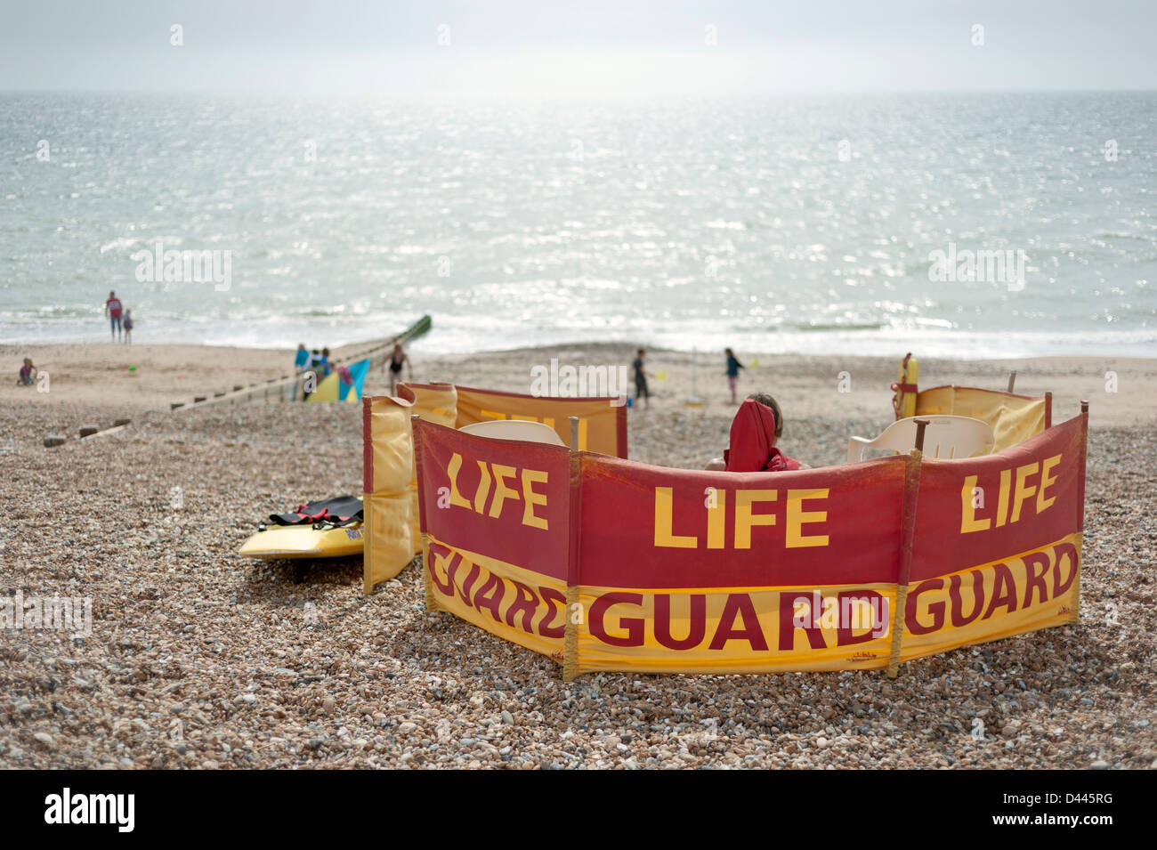 Lifeguard looking out to sea on Brighton beach, East Sussex, England ...