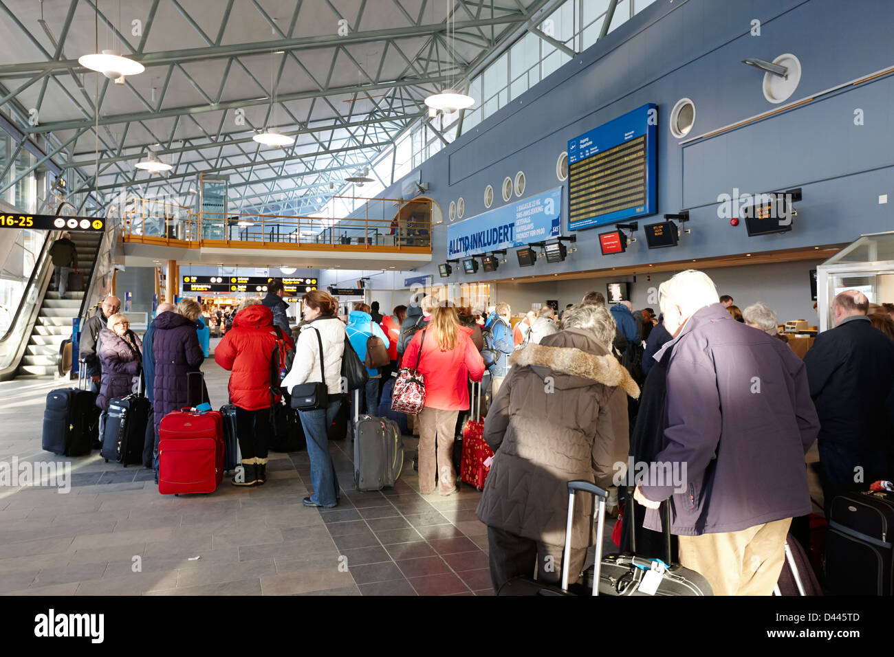 passengers queuing at check in desks in Tromso airport troms Norway ... passengers queuing at check in desks in Tromso airport troms Norway ...