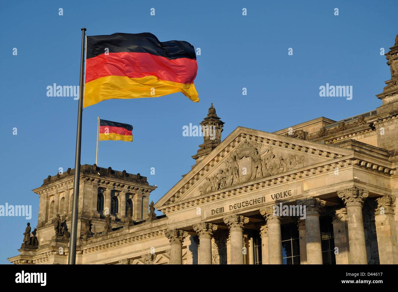 German flags are pictured in front and on the German Reichstag in ...