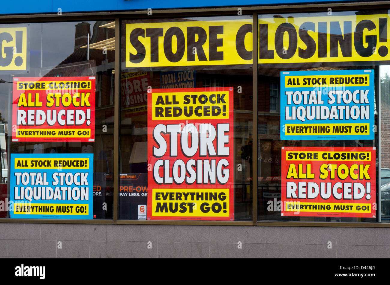 Large colourful posters in a High Street shop window announcing its ...