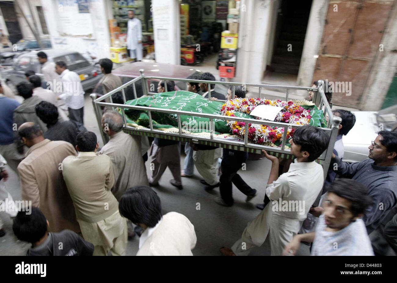 Shiite Muslims carry coffin of victim, who was lost his live in twin ...