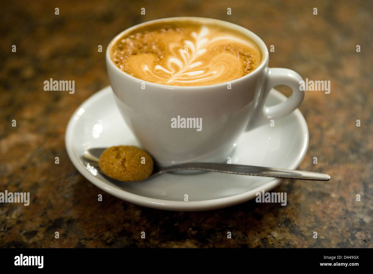 Horizontal close up of a cup of coffee with a decorative pattern made ...