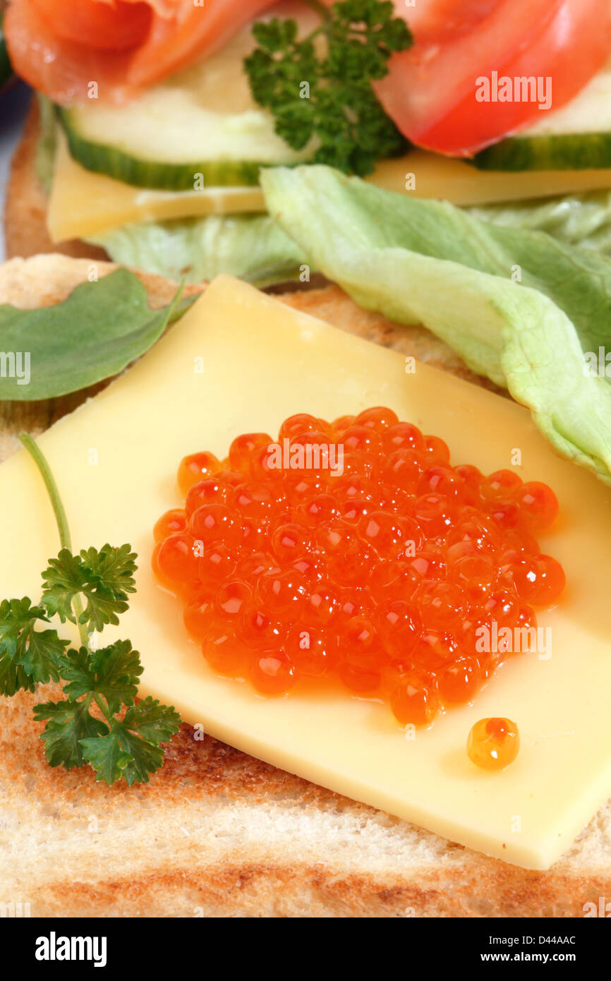Toast with trout caviar, cheese and vegetables Stock Photo - Alamy